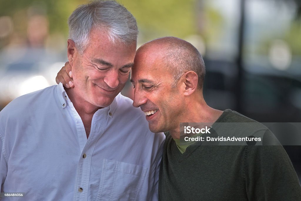 Senior Gay Male Couple Affectionate Loving And Thoughtful Together