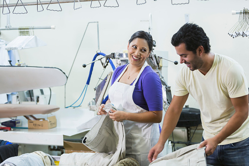 Hispanic Couple Working In Dry Cleaner Stock Photo - Download Image Now ... Hispanic Couple Working In Dry Cleaner Stock Photo - Download Image Now ...