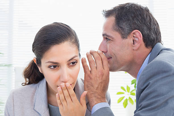 Free Stock Photo of Female coworker whispering in the ear of her young ...