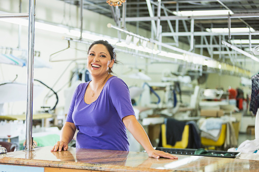 Hispanic Woman Working In A Dry Cleaner Stock Photo - Download Image ... Hispanic Woman Working In A Dry Cleaner Stock Photo - Download Image ...