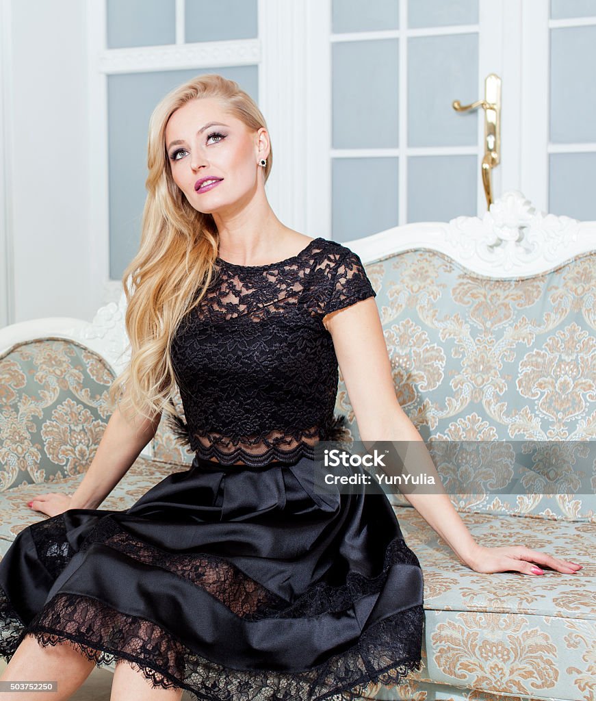 Stylish Elegant Blonde Woman In Beauty Rich Interior Wearing Black