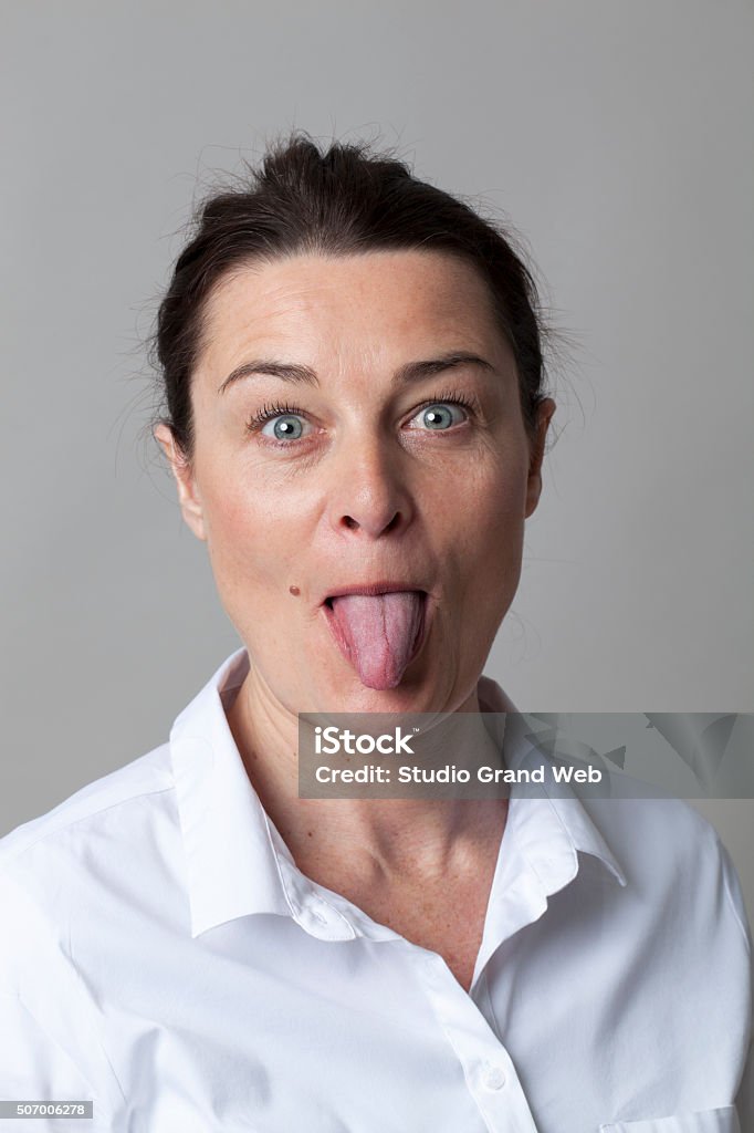 Playful Beautiful Woman Sticking Her Tongue Out For Funny Face Stock