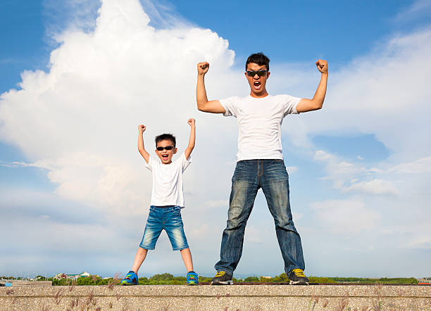 Free Stock Photo of Father and son showing off muscle strength ...