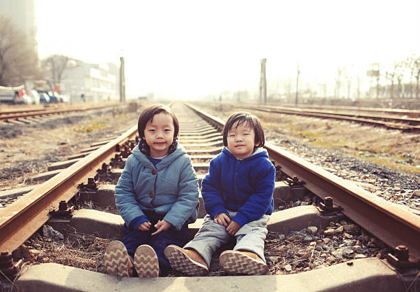 Free Stock Photo of Two friends playing guitar on train tracks ...