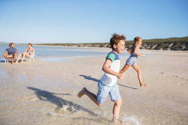Free Stock Photo of Two children playing on a tranquil beach | Download ...