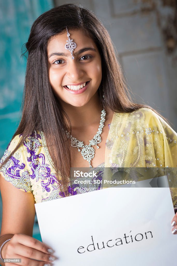 Indian Girl Wearing Traditional Clothing Holding Education Sign Stock