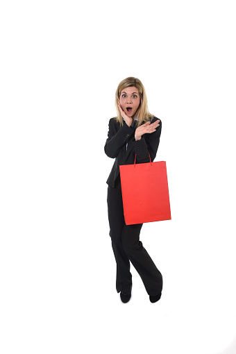 Young Beautiful Woman In Business Suit Holding Red Shopping Bag Stock