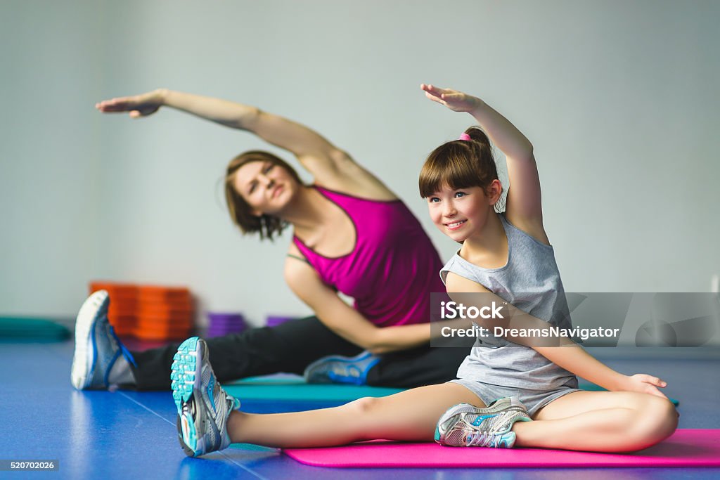 Instructor Or Mother With Daughter Doing Gymnastic Exercises Stock