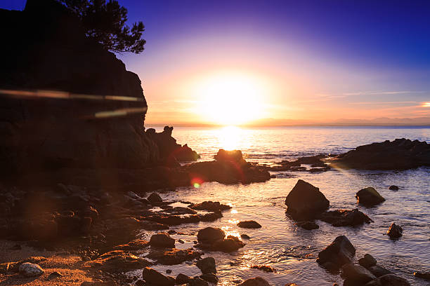 Free Stock Photo of Sunset over soft waves and boulder formation ...