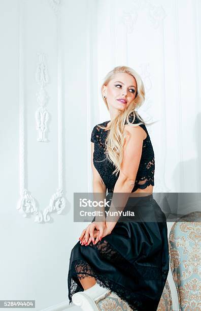 Stylish Elegant Blonde Woman In Beauty Rich Interior Wearing Black