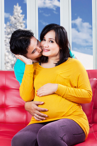 Cheerful Pregnant Mother Kissed By Her Husband Stock Photo - Download ... Cheerful Pregnant Mother Kissed By Her Husband Stock Photo - Download ...
