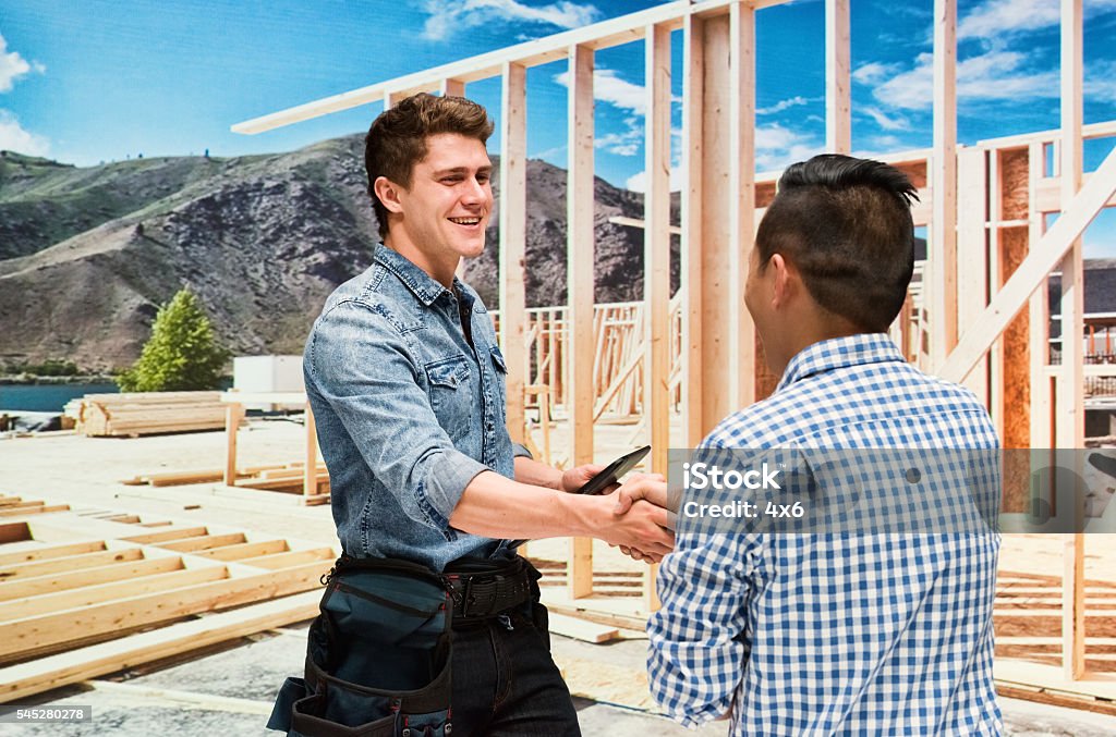 Building Contractor Giving A Handshake With Client Stock Photo ... Building Contractor Giving A Handshake With Client Stock Photo ...