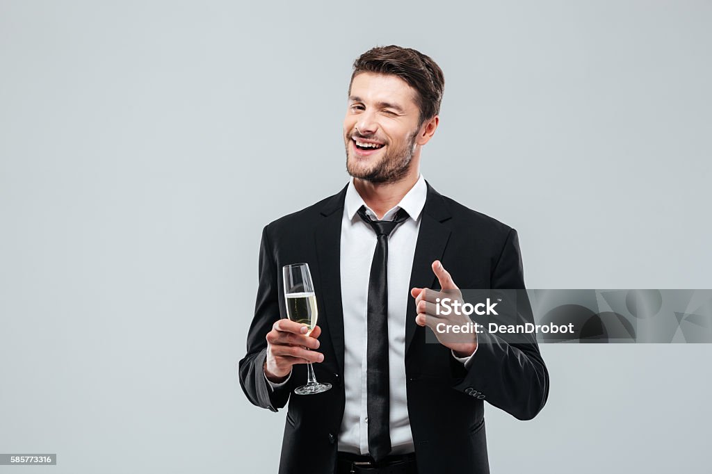 Happy Handsome Young Businessman Drinking Champagne And Pointing On You