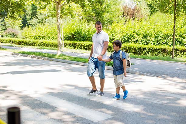 Free Stock Photo of Father and Son crossing a road with trees in the ...