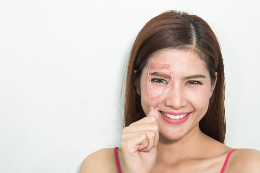Portrait Of Cheerful Beautiful Woman Making Curl Eyelashes Using Stock