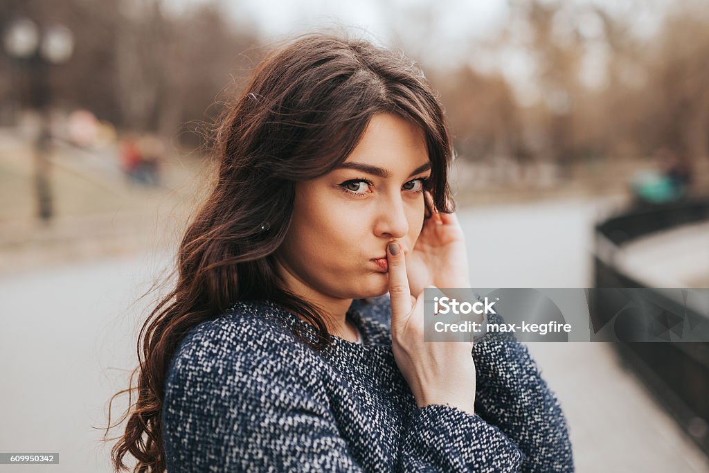 Closeup Portrait Secretive Young Woman Placing Finger On Lips Stock