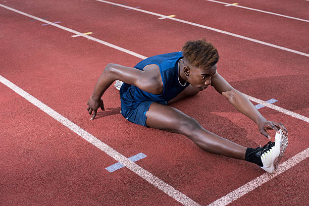 Free Stock Photo of Athlete stretching on a running track | Download ...