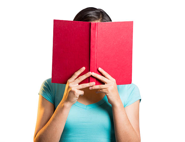 Free Stock Photo of Overworked young student hiding behind open book ...
