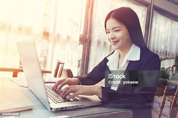 Smiling Young Asian Executive Business Woman Working On Her Computer ... Smiling Young Asian Executive Business Woman Working On Her Computer ...