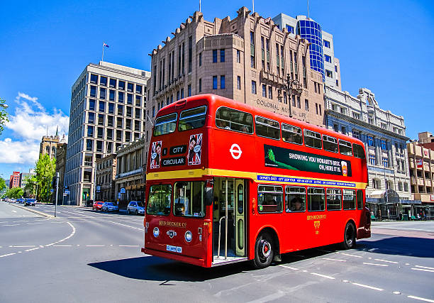 Free Stock Photo of A double decker bus in front of a tall building ...