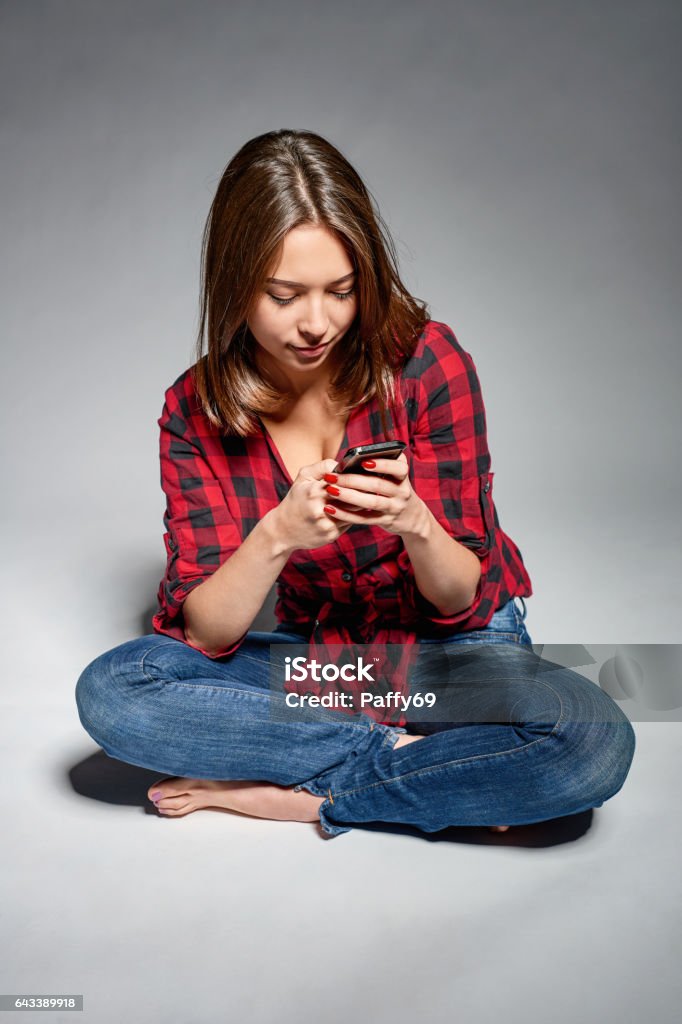 Smiling Teen Girl Sitting Barefooted At Floor Smiling At Camera Stock