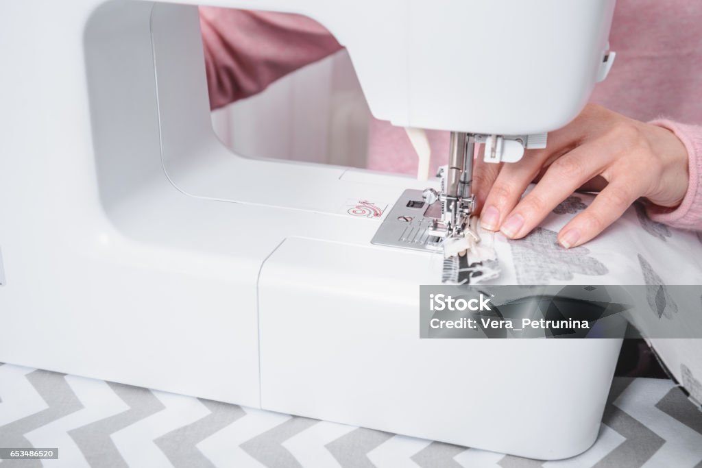 Beautiful Woman Seamstress Sew On The Sewing Machine Clothes Stock