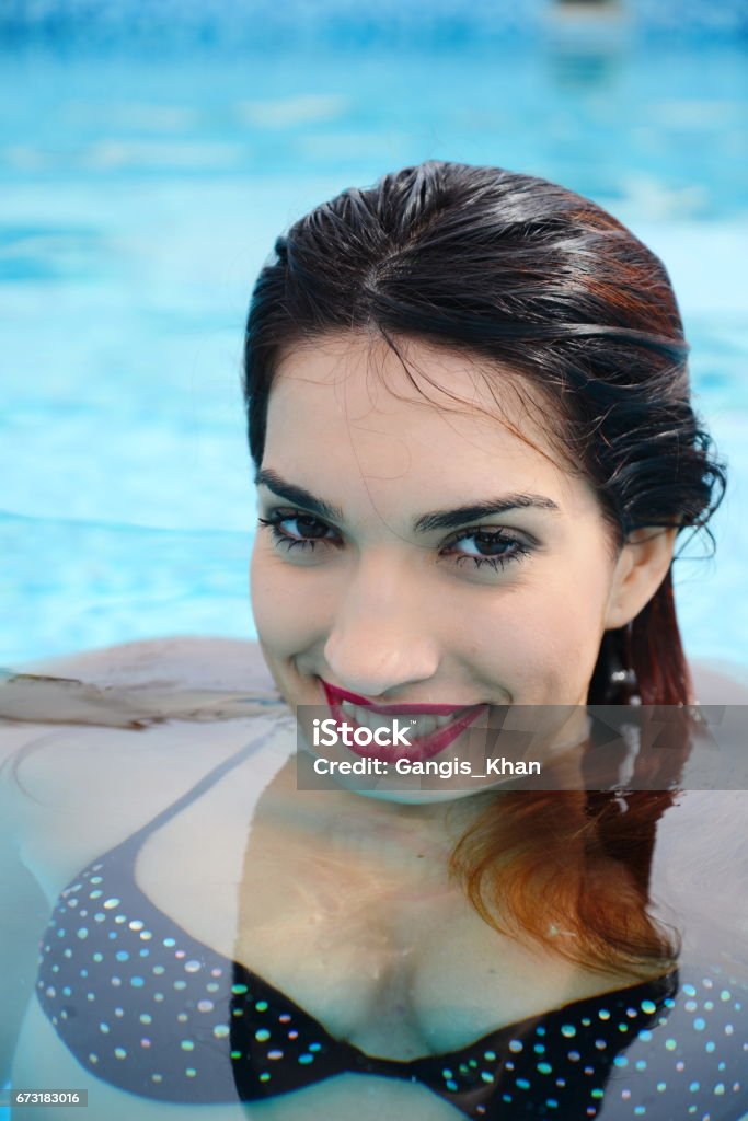 Beautiful Young Woman Relaxing In Water By The Swimming Pool Stock