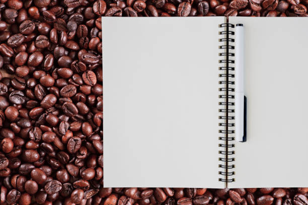 Free Stock Photo of A pile of coffee beans and a spiral notebook ...