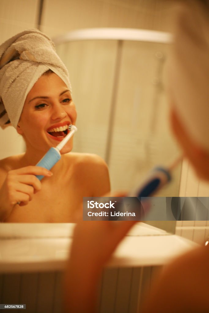 Woman In Bathroom Brushing Teeth And Smiling Image Of Pretty Female