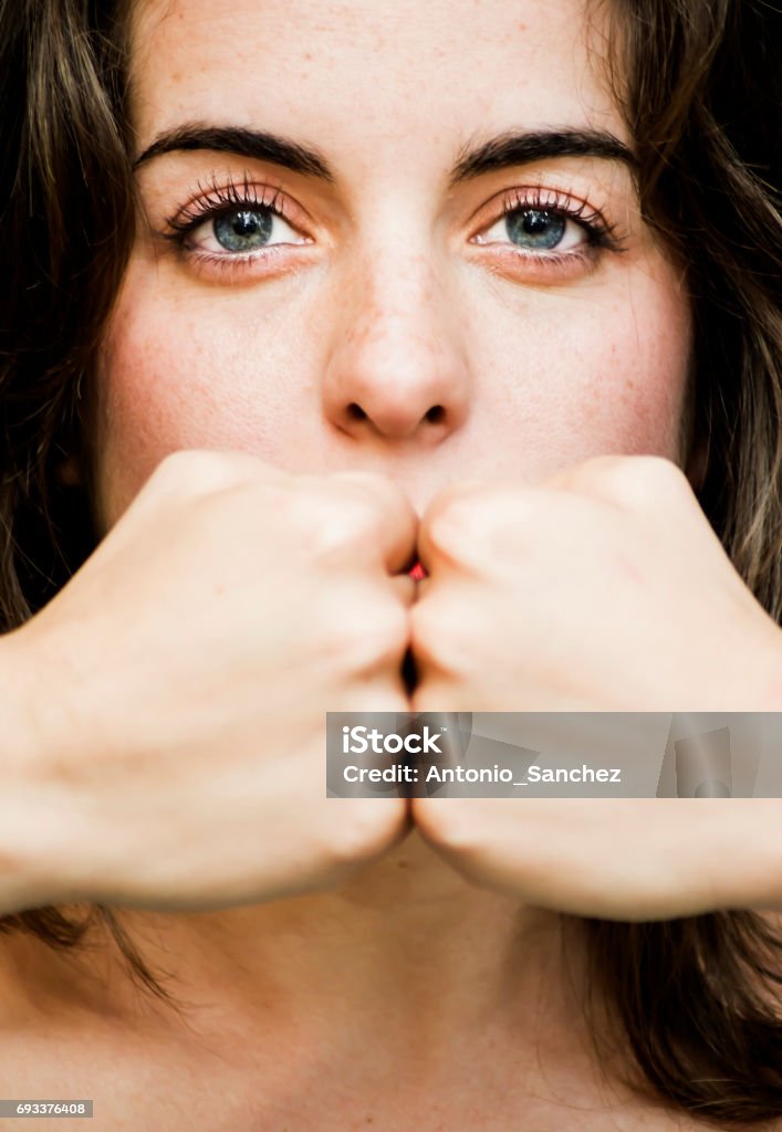 Portrait Of A Beautiful Woman Covering Her Mouth With Her Hands On