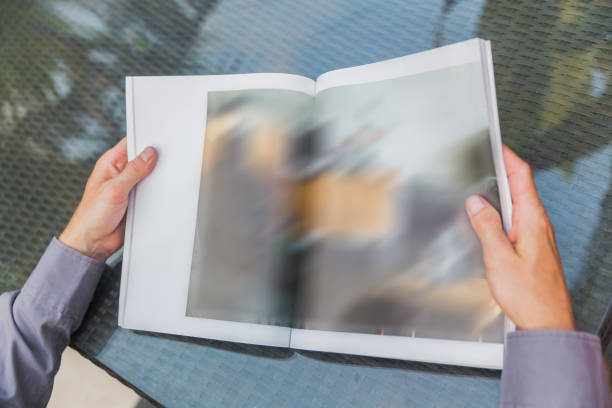 Free Stock Photo of Person Holding Magazine Over Table | Download Free ...