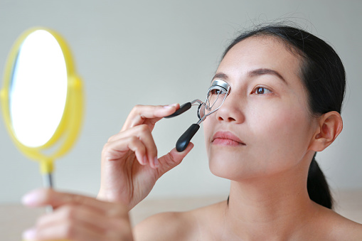 Portrait Of Beautiful Woman Making Curl Eyelashes Beauty Concept Stock