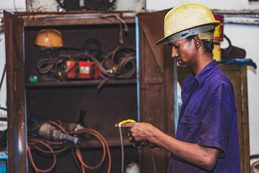 Young Factory Employee Correcting A Cable Stock Photo - Download Image ... Young Factory Employee Correcting A Cable Stock Photo - Download Image ...