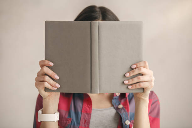 Free Stock Photo of Woman Holding Book Up to Face | Download Free ...