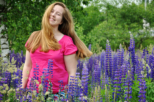 Portrait Of Smiling Young European Redhaired Girl In A Pink Blouse In A