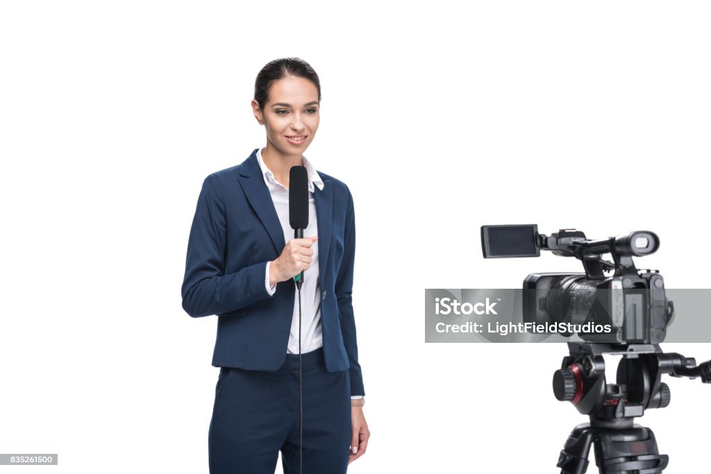 Beautiful Smiling Female Journalist With Microphone Looking At Camera
