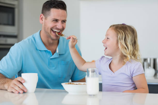 Daughter Feeding Her Father Cereal Stock Photos, Pictures & Royalty ... Daughter Feeding Her Father Cereal Stock Photos, Pictures & Royalty ...