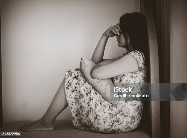 Black And White Depressed Woman Hug Her Knee And Cry While Sitting