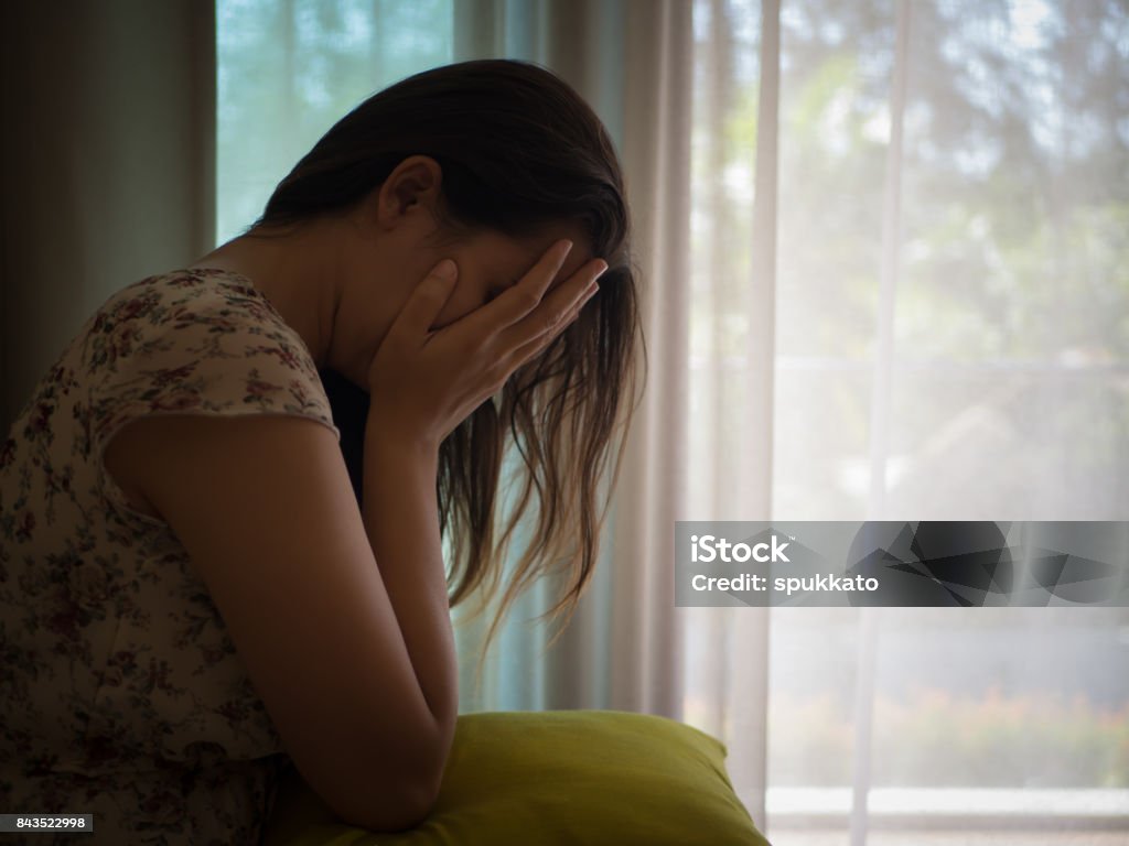 Closeup Depressed Woman Hug Her Knee And Cry While Sitting Alone On The