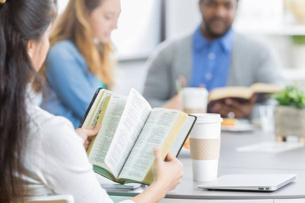 Free Stock Photo of Person studying an open Bible on wood table ...