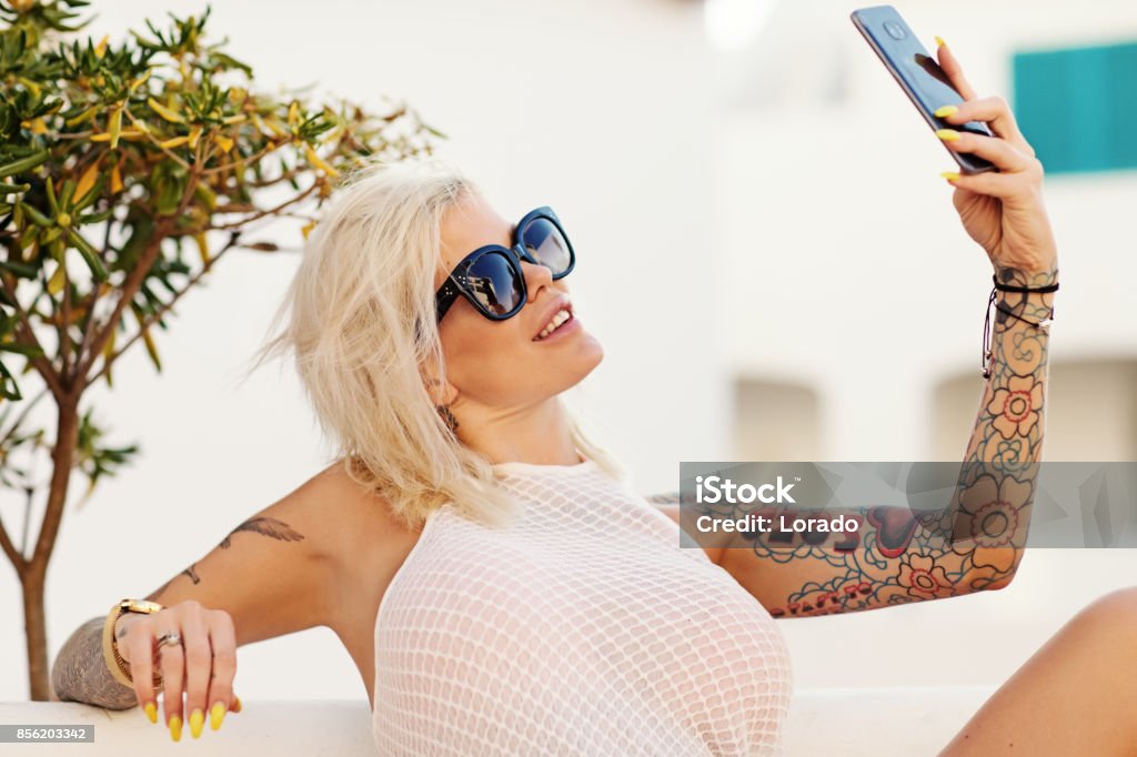 Beautiful Blonde Scandinavian Woman Using Smartphone In Sunny Summer