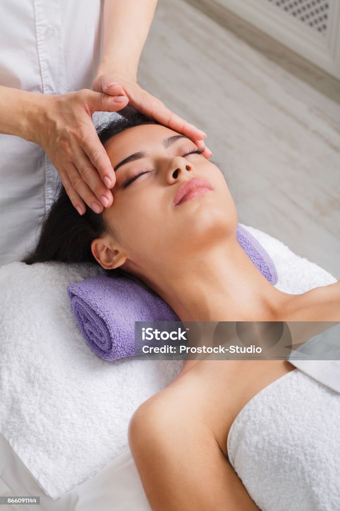 Woman Beautician Doctor Make Head Massage In Spa Wellness Center Stock