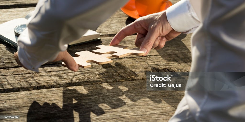 Man Putting Together Two Puzzle Pieces Stock Photo - Download Image Now ... Man Putting Together Two Puzzle Pieces Stock Photo - Download Image Now ...
