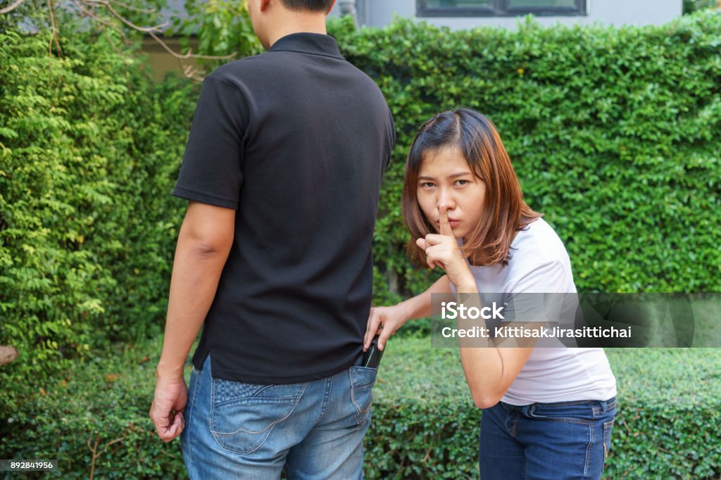 Female Pickpocket Stealing A Wallet From Behind Pocket On Jeans And