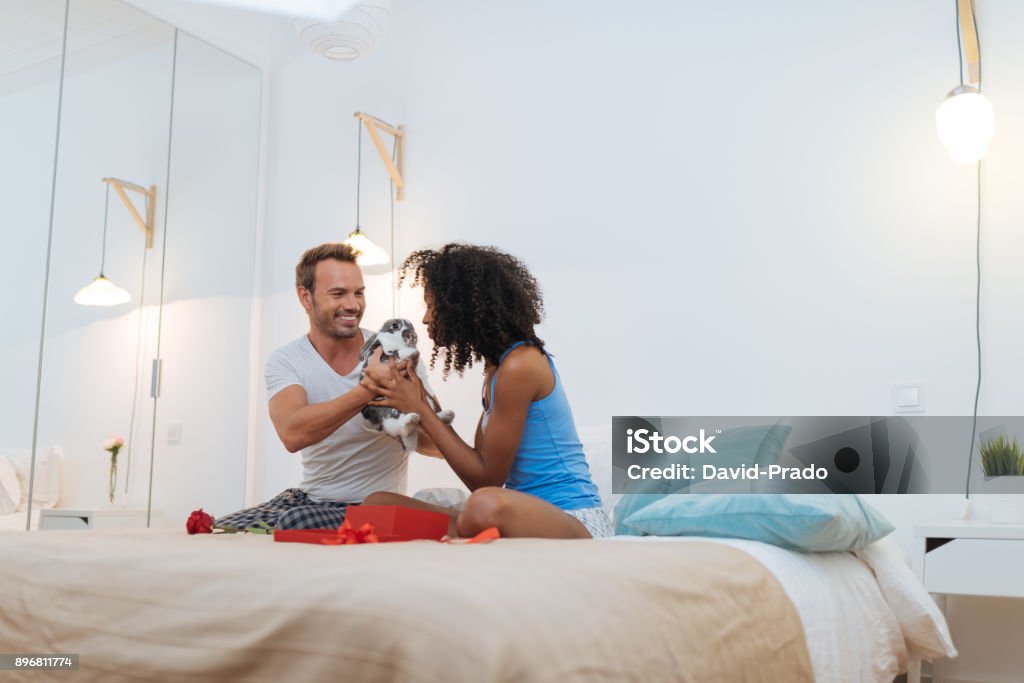 Young Beautiful Interracial Couple In Bed Giving A Surprise T And