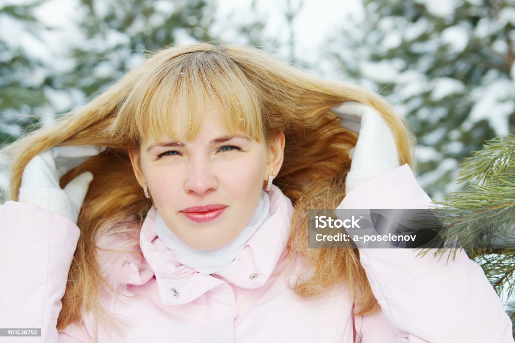 Beautiful Young Woman Touches Her Golden Hair Outdoor In Winter Stock