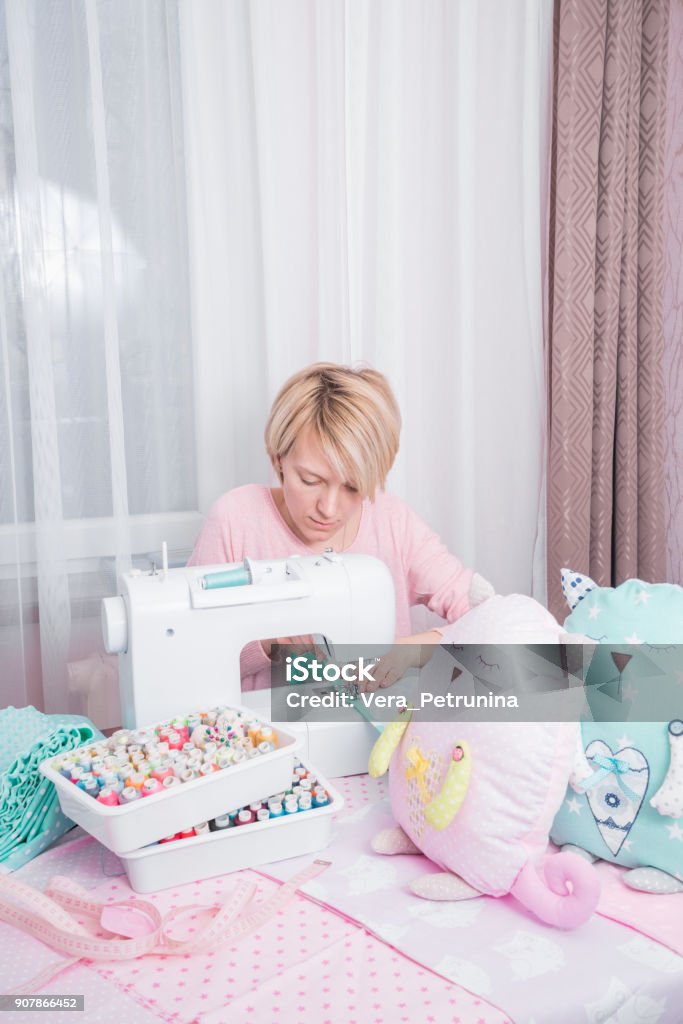 Beautiful Woman Seamstress Sew On The Sewing Machine Clothes Stock