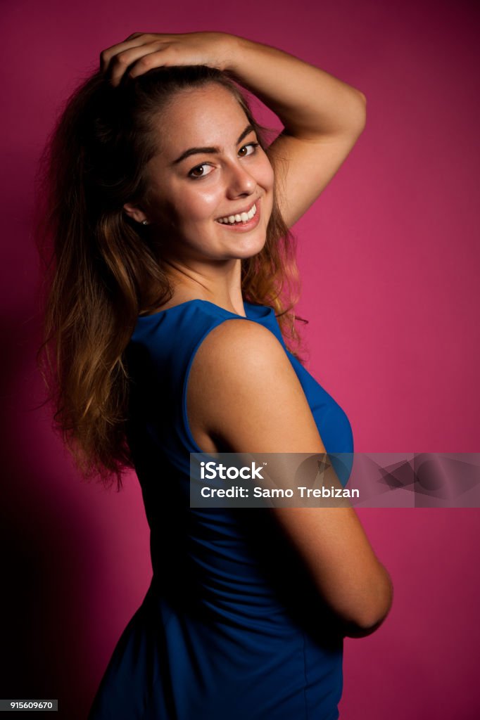 Beautiful Young Caucasian Woman In Blue Dress Isolate Over Pink