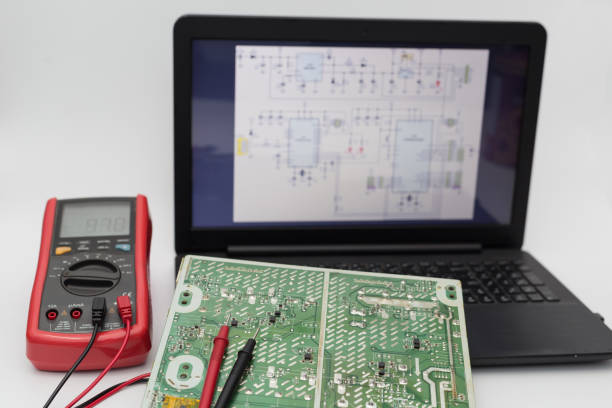 Digital multimeter and circuit board with Electrical diagrams by laptop ...