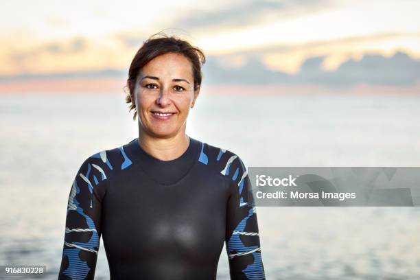 Smiling Mature Woman In Wetsuit At Beach Stock Photo - Download Image ... Smiling Mature Woman In Wetsuit At Beach Stock Photo - Download Image ...